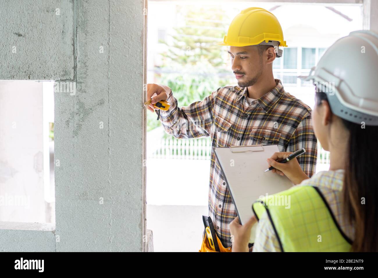 inspector checking and measure by measuring tape with assistant in ...