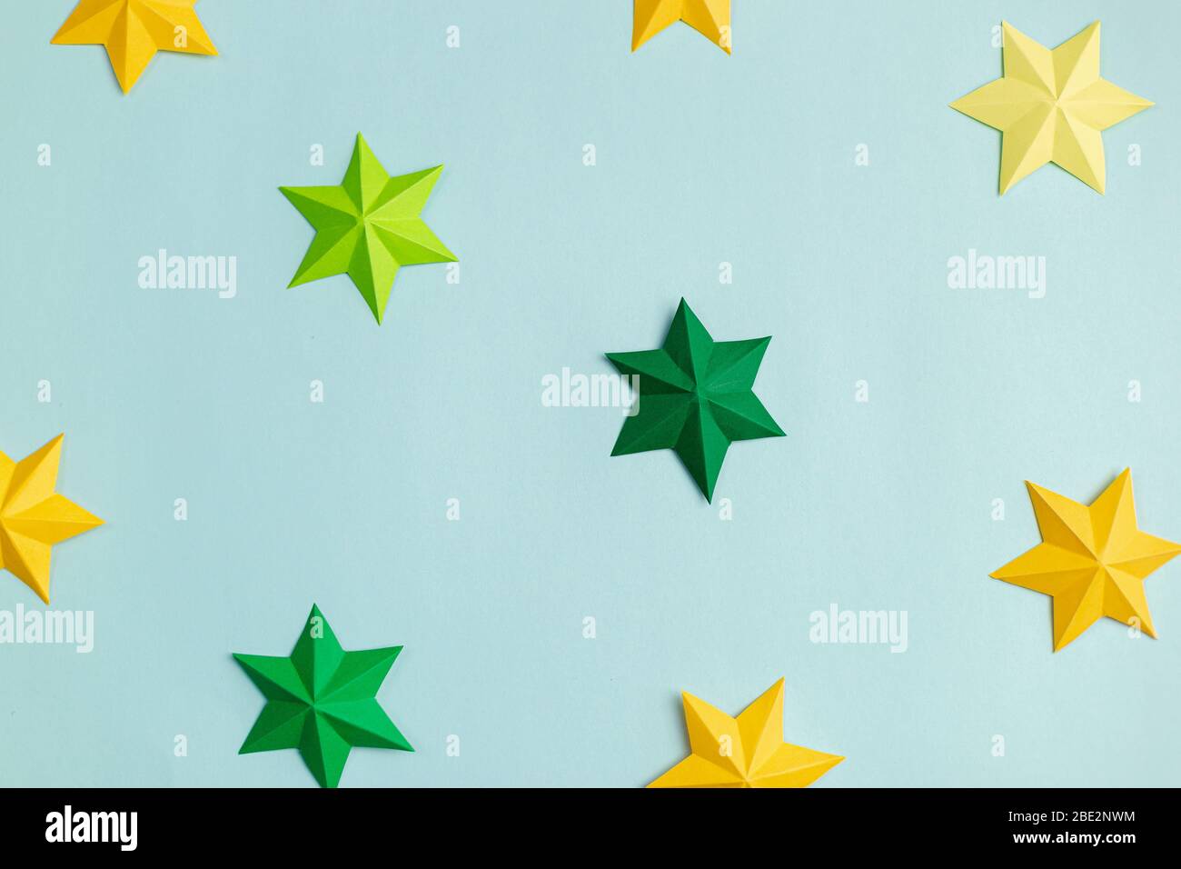 Colored paper stars over blue background Stock Photo - Alamy