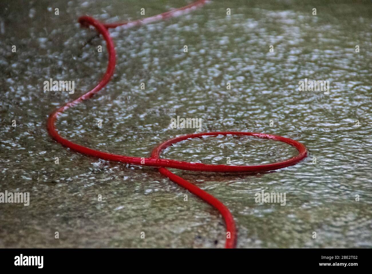 Red cable at a construction site during a major rain Stock Photo - Alamy