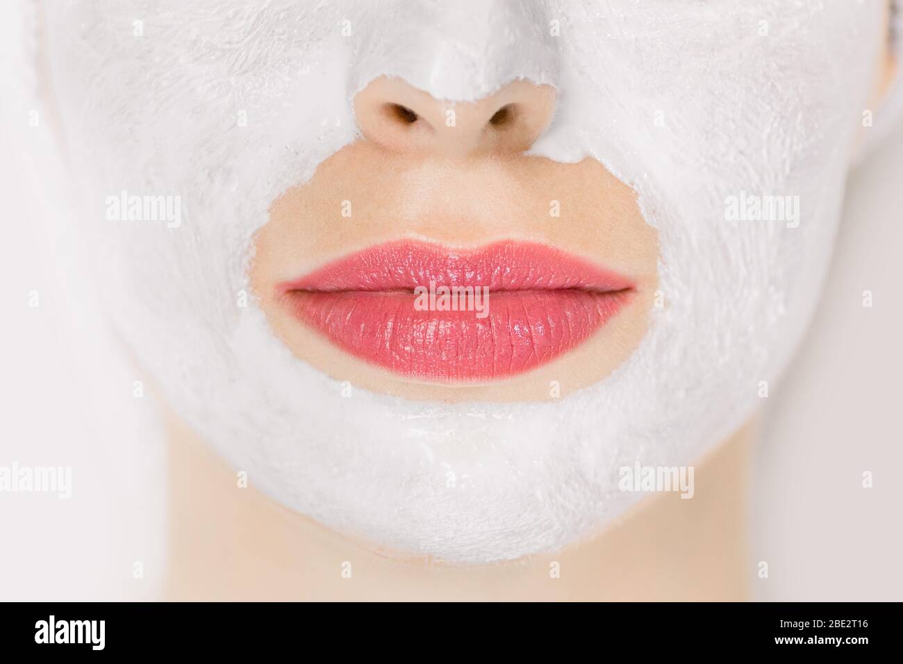 Close up macro photo of bottom of a woman's face with white mud mask on ...