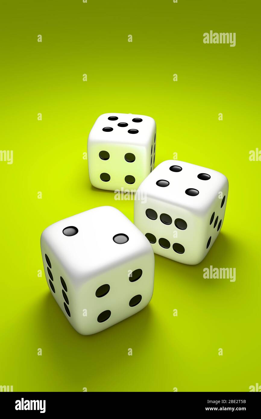 three dice on a green background Stock Photo - Alamy