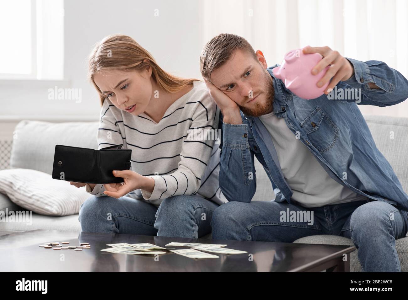 Desperate couple counting last money savings at home Stock Photo - Alamy