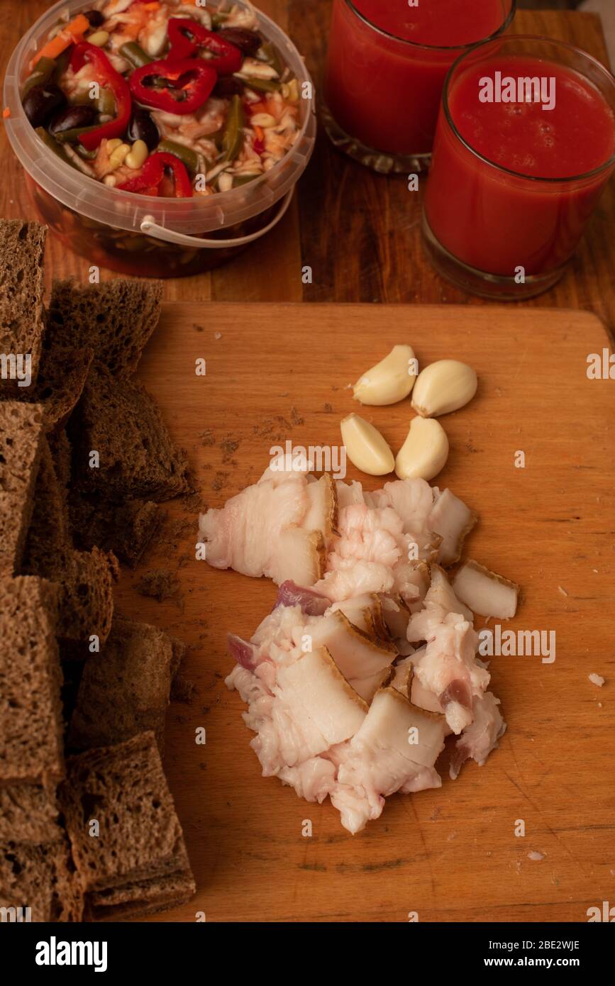 Traditional Russian snack. Salo bread pickles. Two glasses of tomato ...