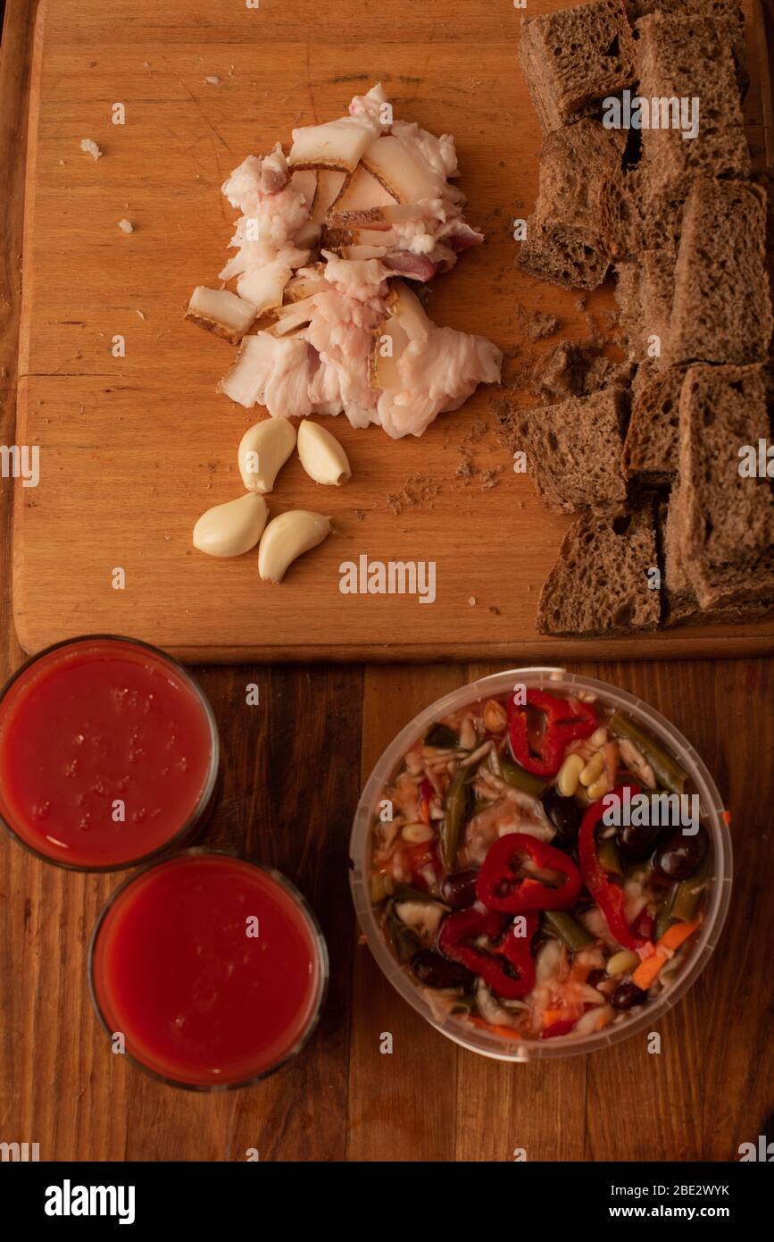 Traditional Russian snack. Salo bread pickles. Two glasses of tomato ...