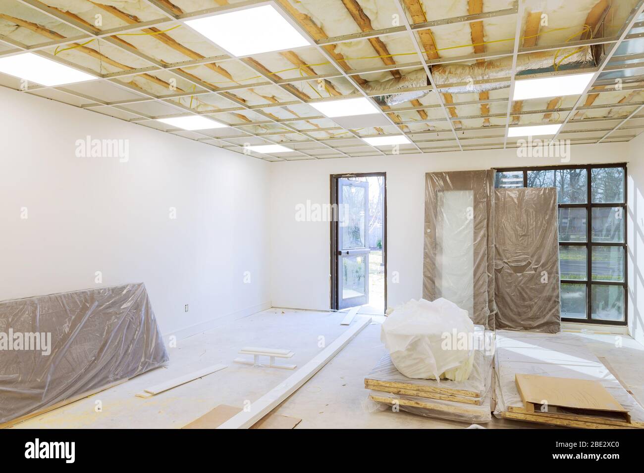 Frame of metal rails of a modern false ceiling with a built-in lamp ...
