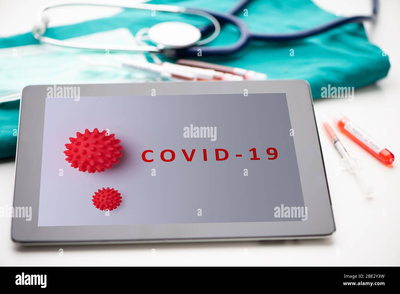 White health center desk with tablet with coronavirus title and medical ...