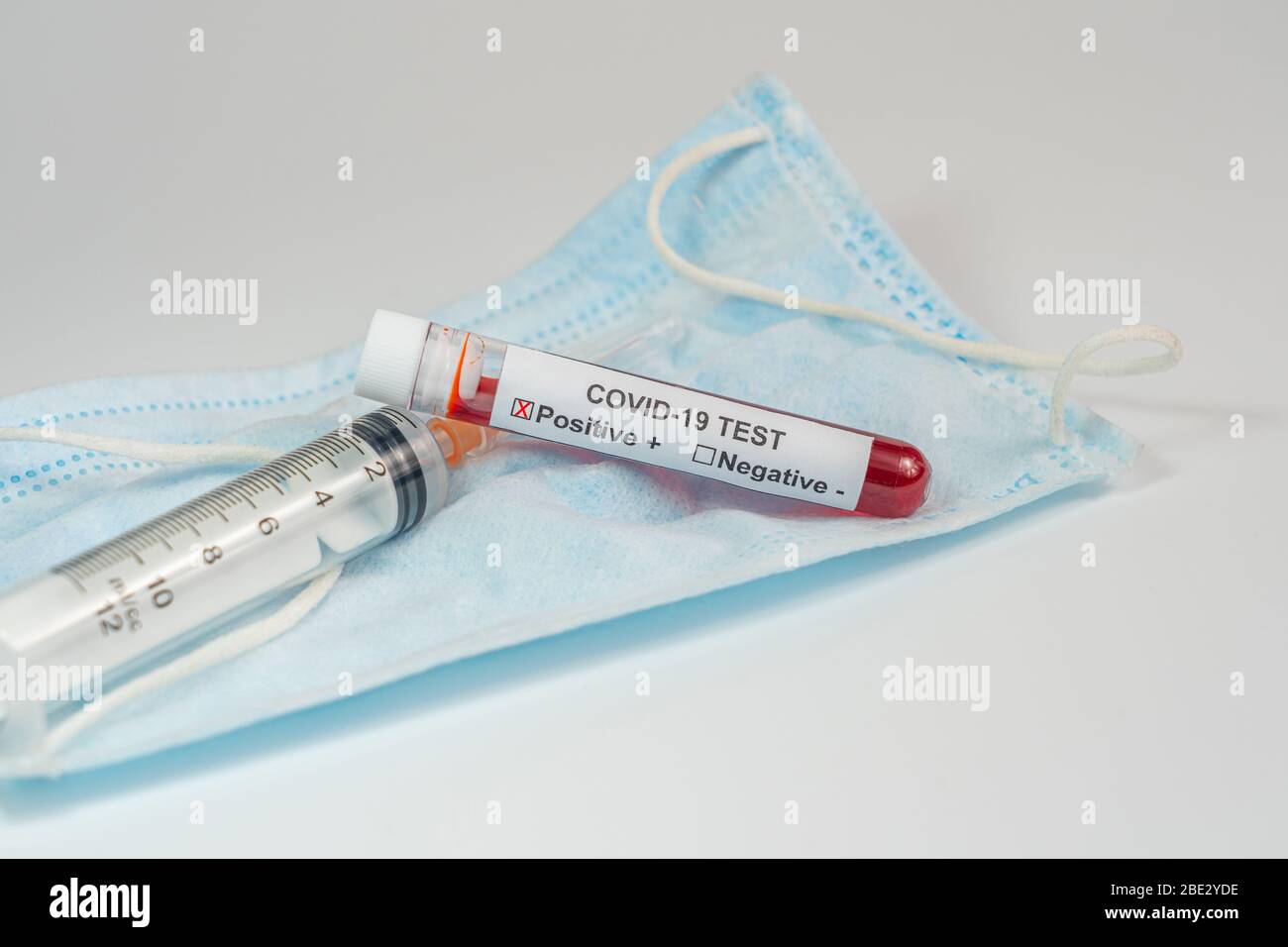 Blood test sample of positive COVID-19 infection on white background ...