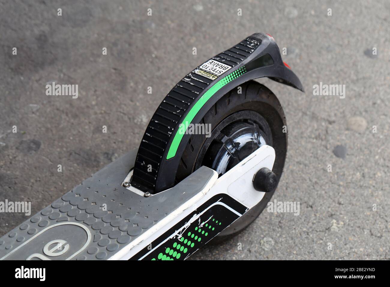 Closeup of an electric rental scooter from brand Lime. Rent these skip ...