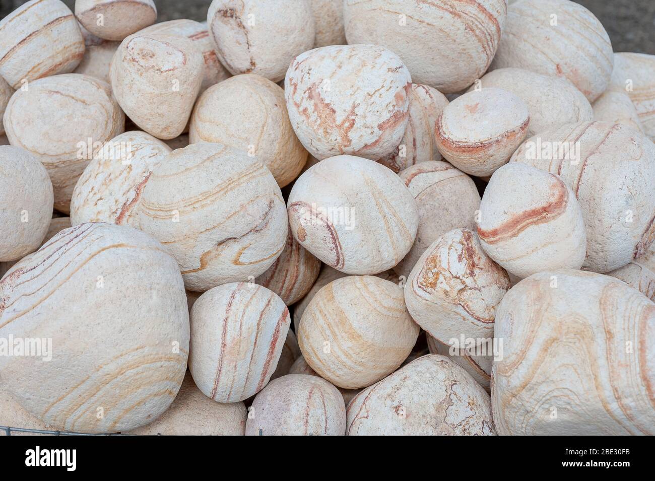 Rounded pebble natural stones texture background Stock Photo - Alamy