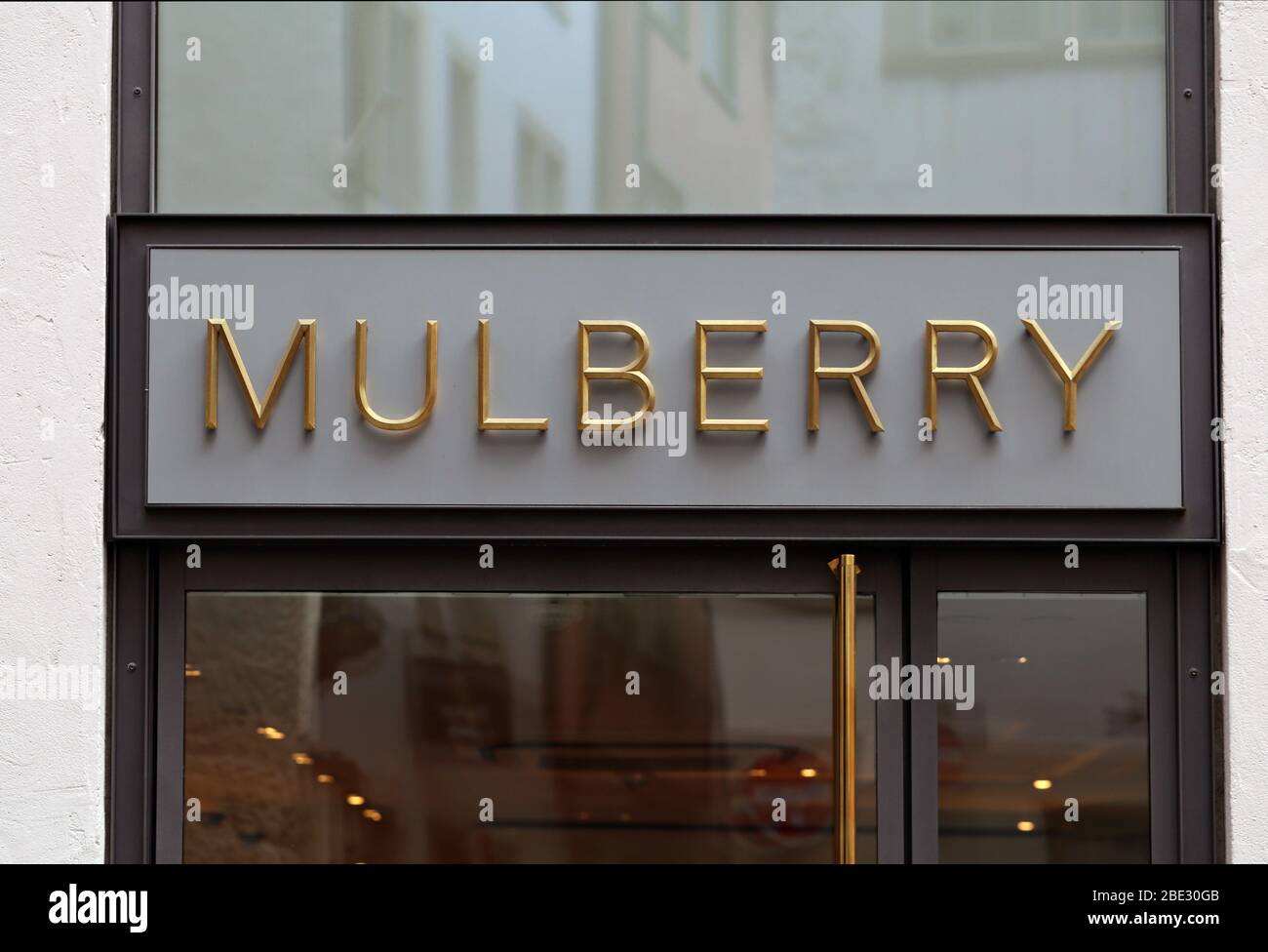 Logo sign of Mulberry on a wall of an old building located in downtown ...