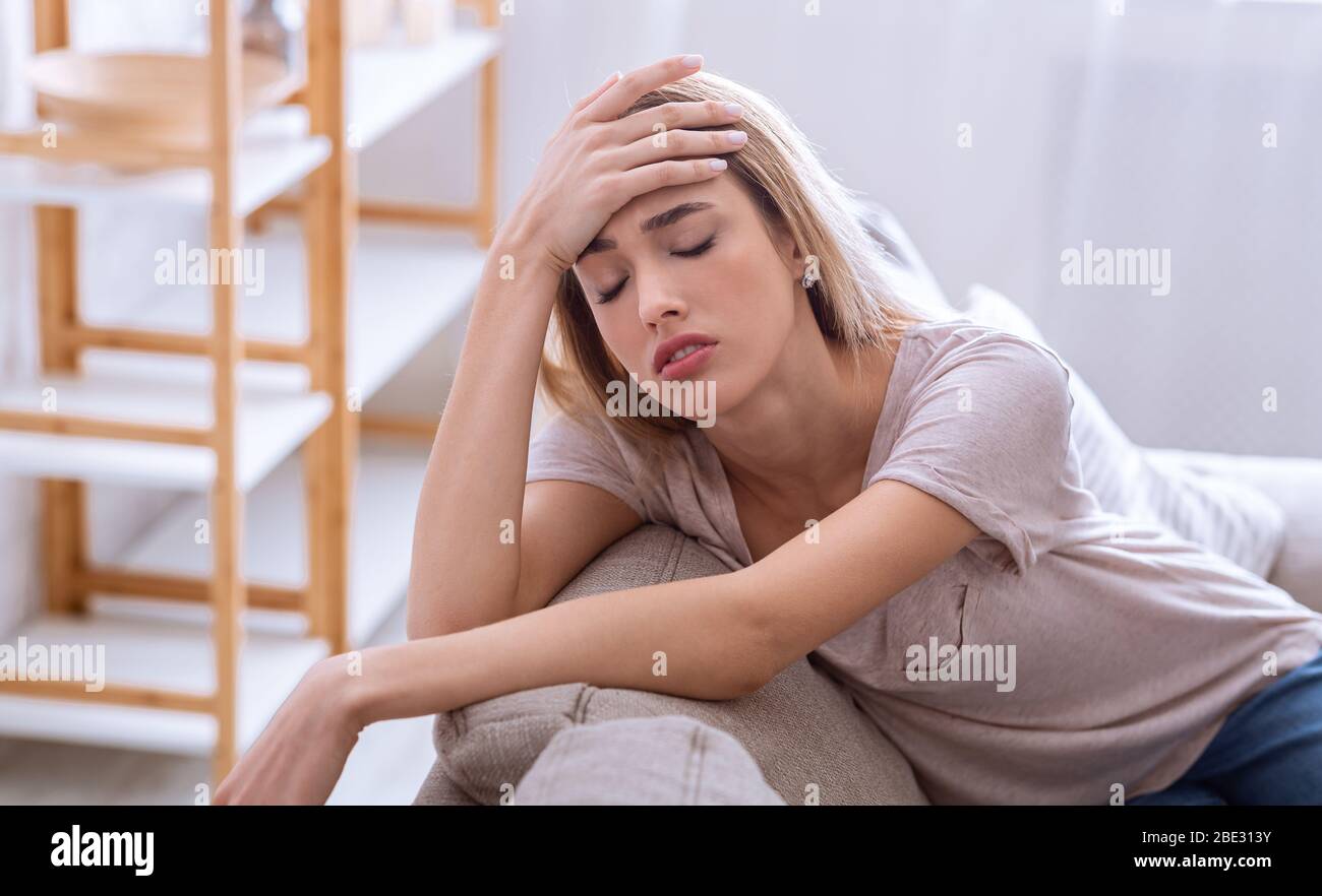 First symptoms of disease. Woman suffering from headache Stock Photo ...