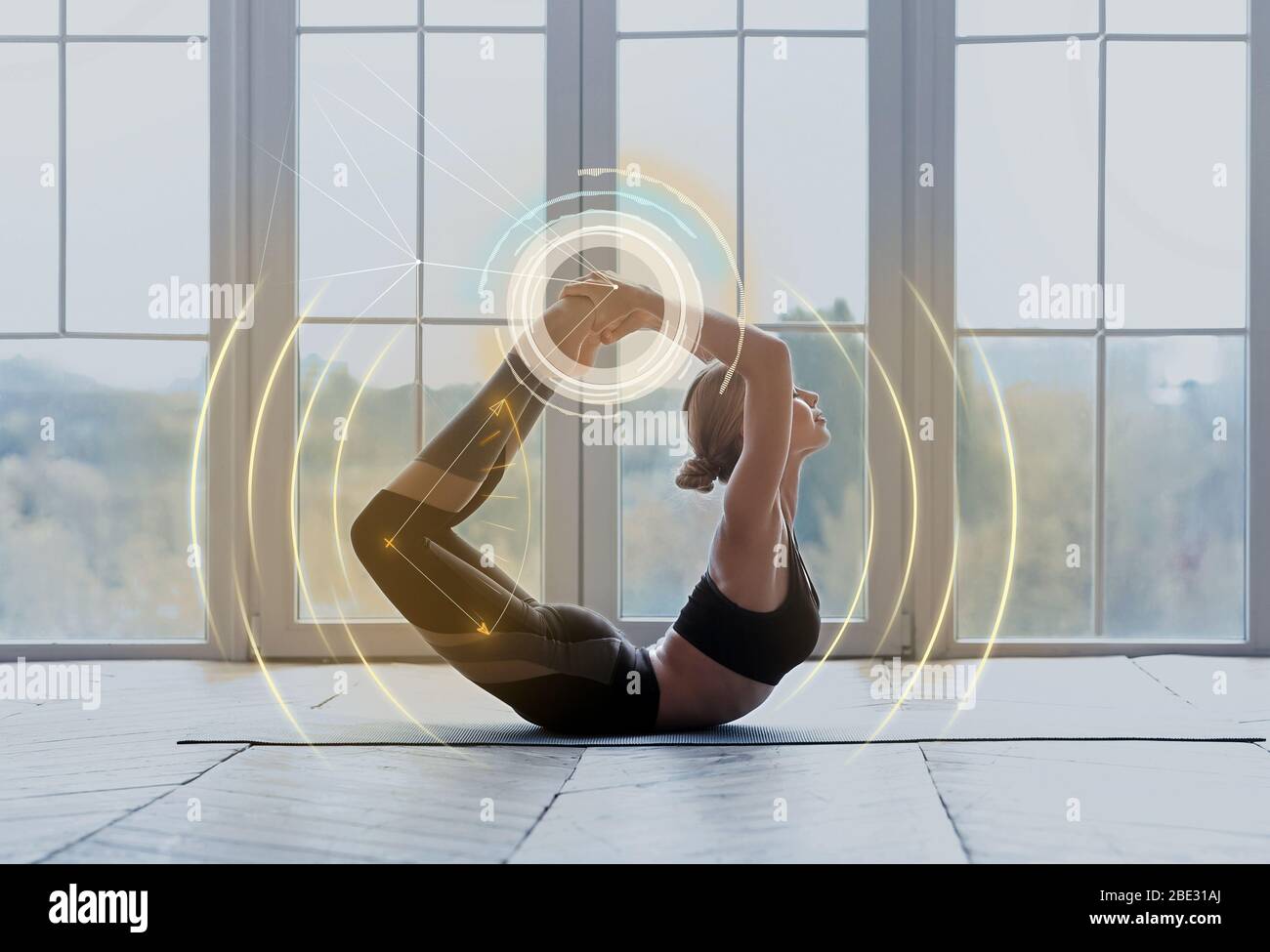 Stretching and flexibility. Fit girl in bow yoga pose near large window ...