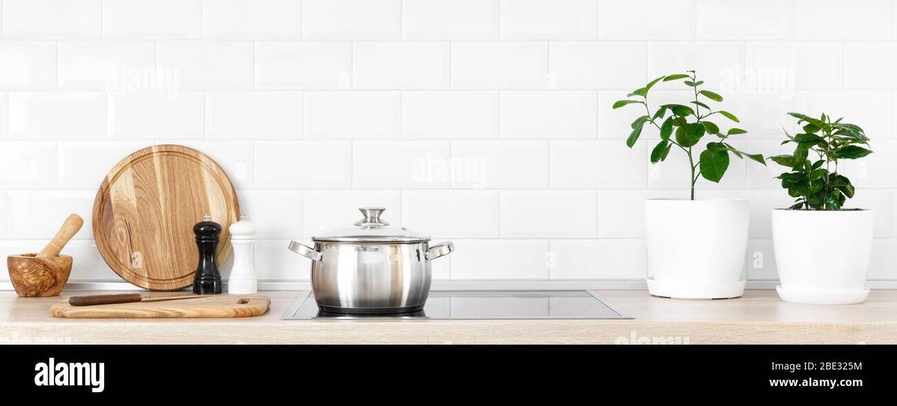 White modern kitchen interior with wooden worktop and kitchenware ...