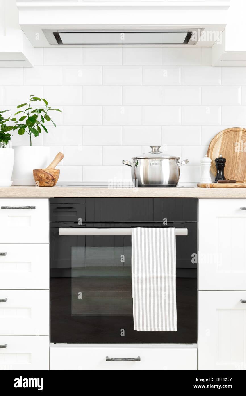 White modern kitchen interior with wooden worktop and kitchenware ...