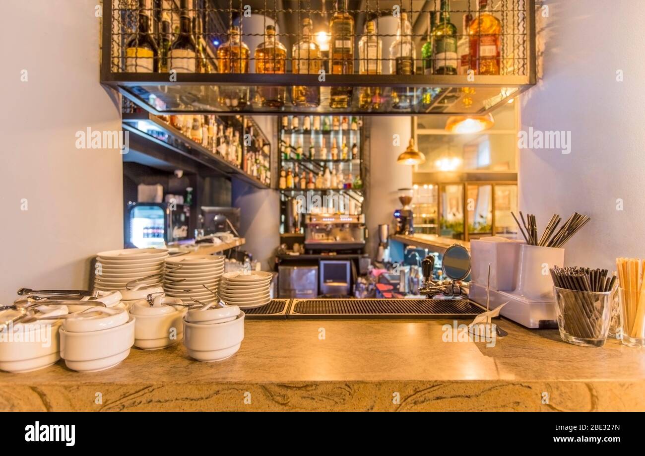 Bar counter with elite alcohol and clean dishes for tea Stock Photo - Alamy