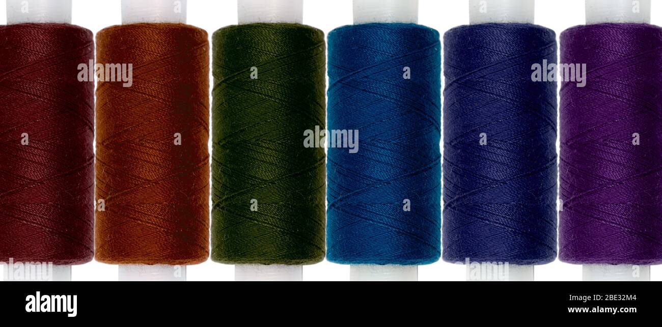 Hanks of multi-coloured threads for embroidery on a white background ...