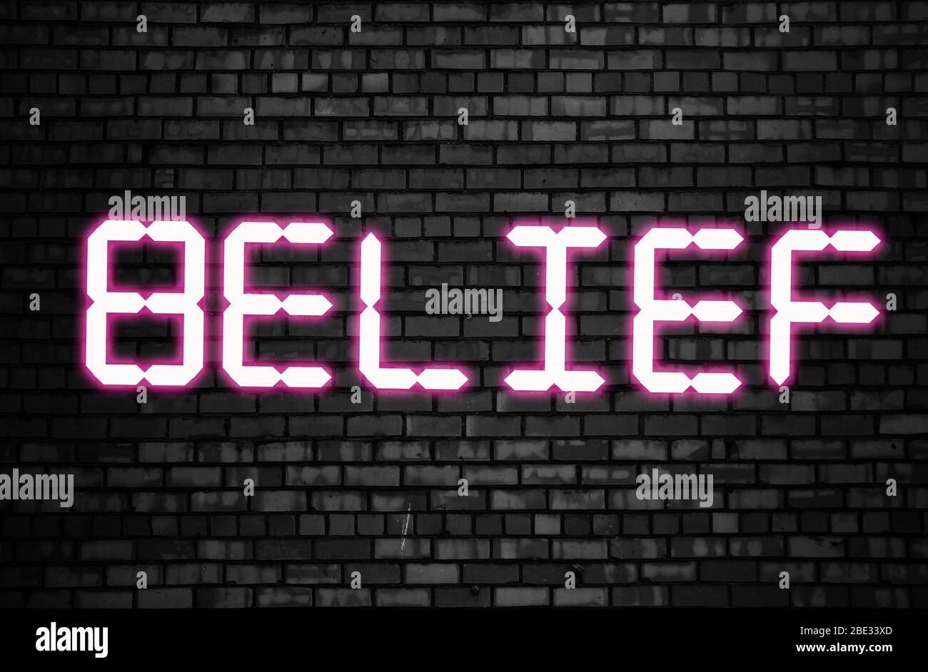 Belief word glowing in neon pink on black brick wall. Believes and ...