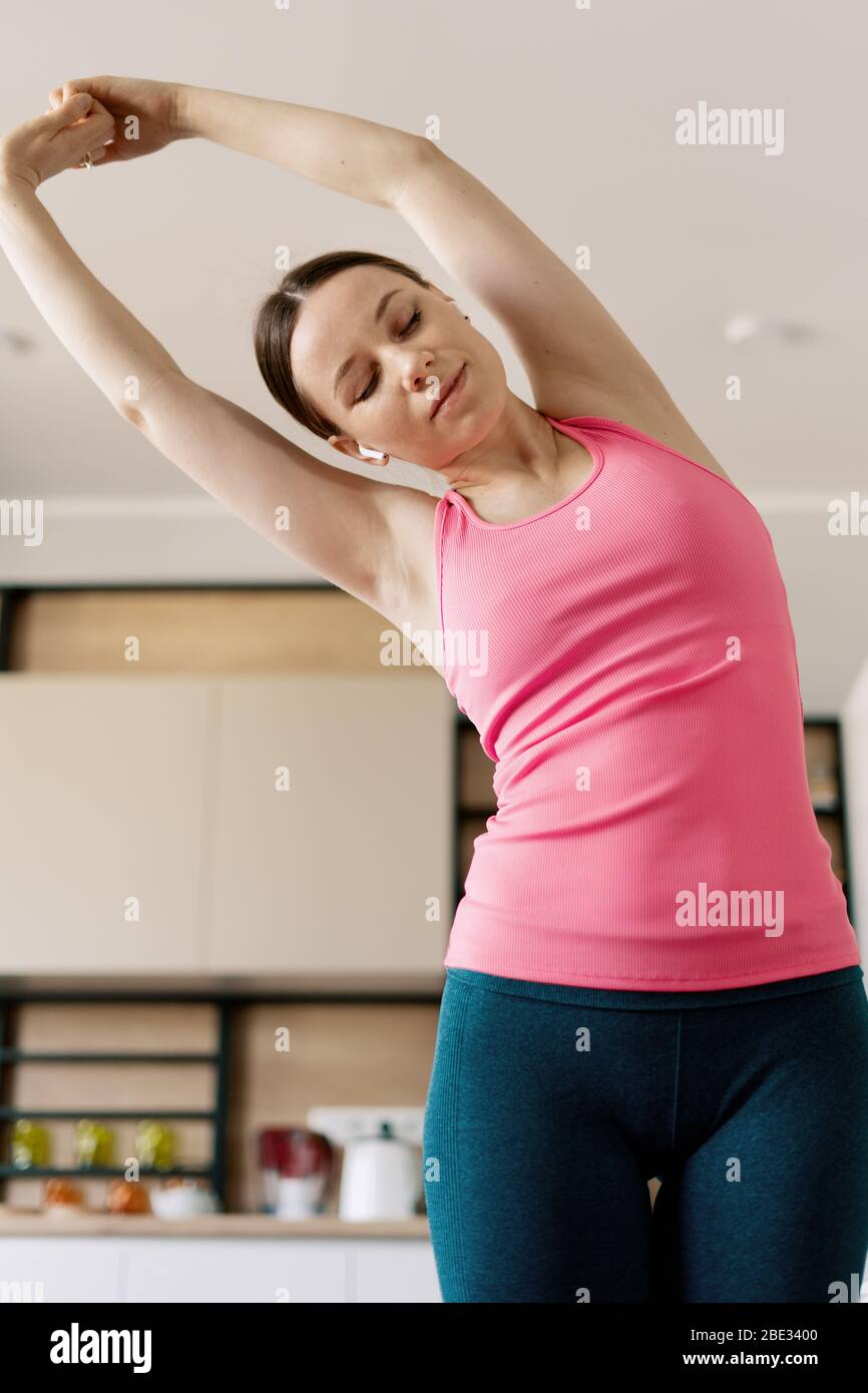 Attractive woman practicing stretching in the leaving room Stock Photo ...