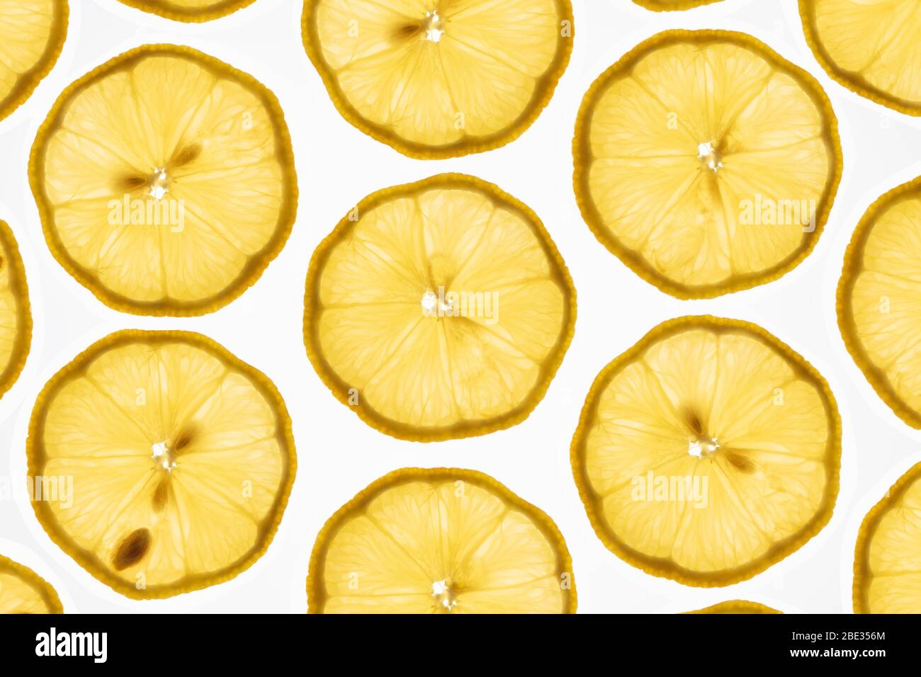 a very interesting pattern of transparent lemon slices against a bright ...