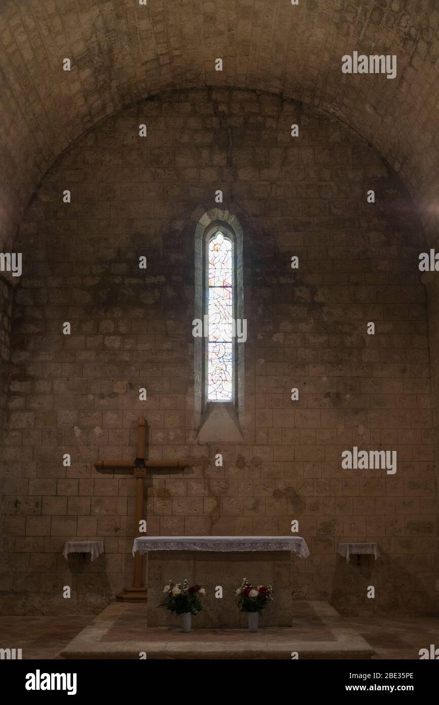 Decorated stained glass window and altar in the small church in the ...