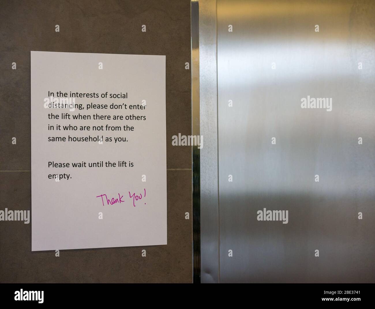Notice on lift door in apartment block of flats warning of social ...