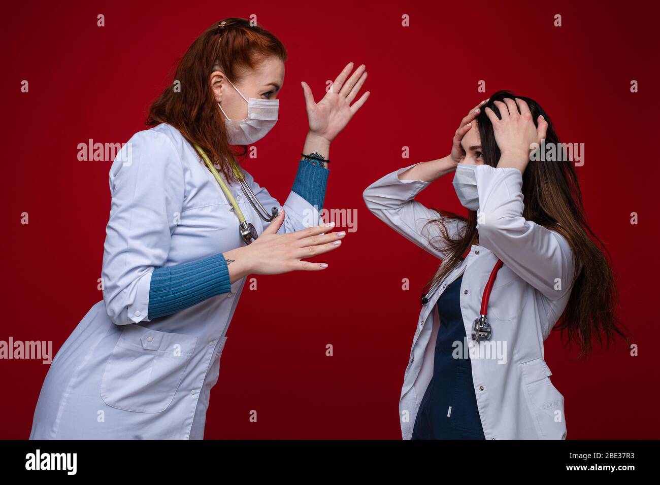Portrait of two female doctors in medical clothes with phonendoscope ...