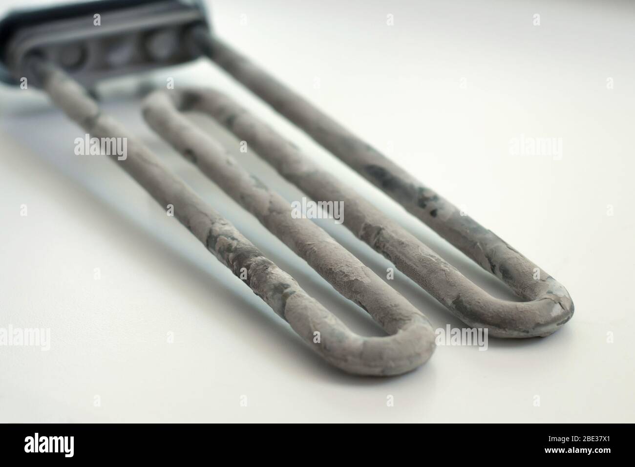 Washing machine heater on a white background Stock Photo - Alamy