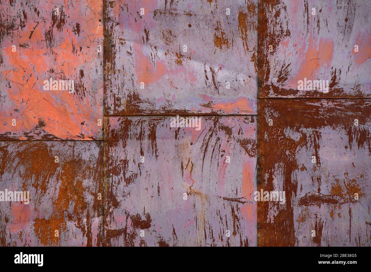 Rusty wall made of tin sheets forming an up-going chart. Red rust ...