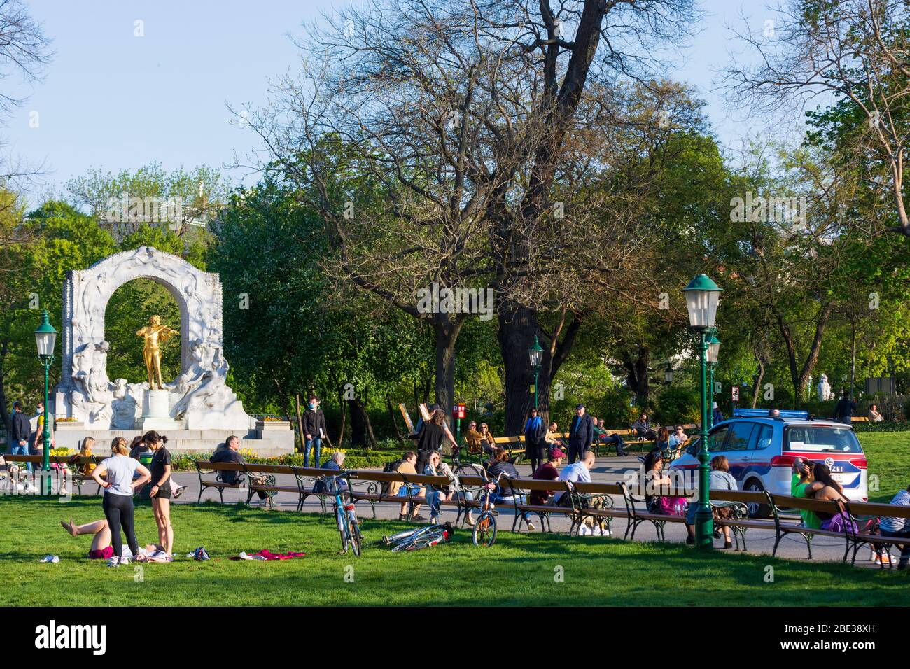 Wien, Vienna: park Stadtpark, police car, Johann Strauß Monument, people at meadow doing ...