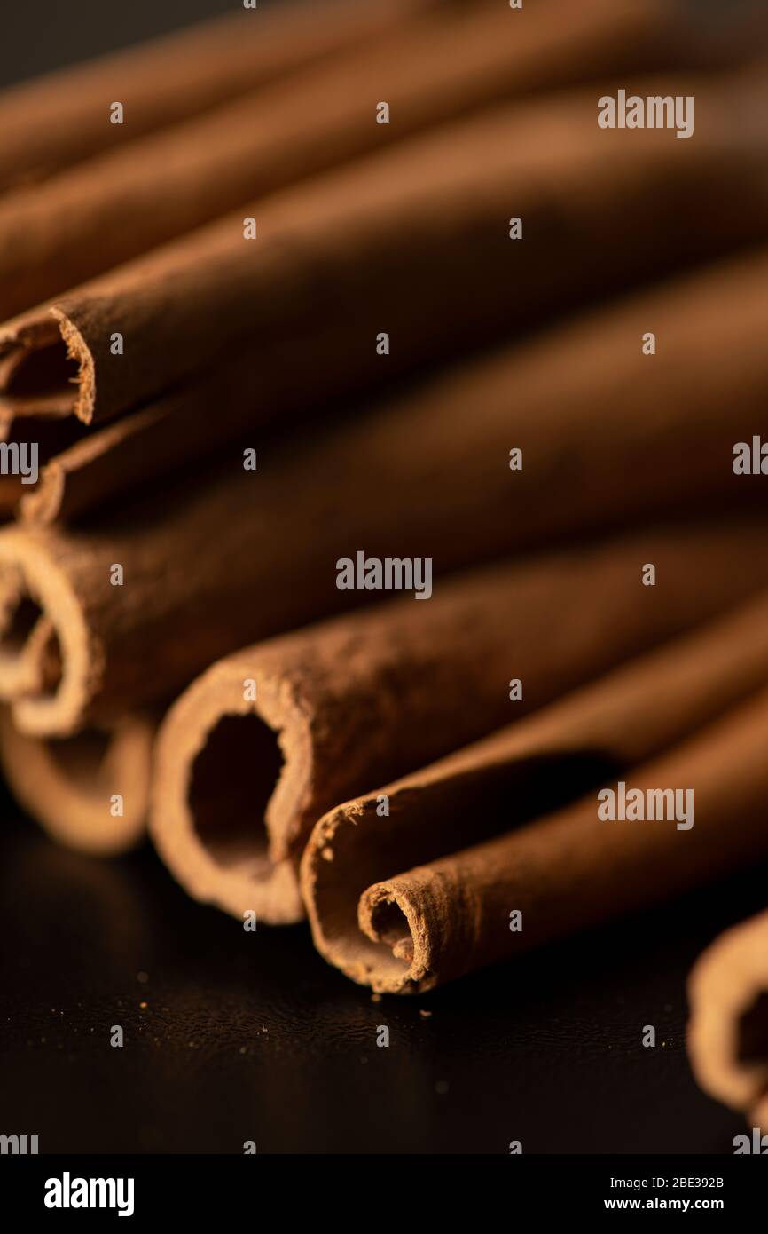 Cinnamon sticks close up photography on a dark background Stock Photo ...