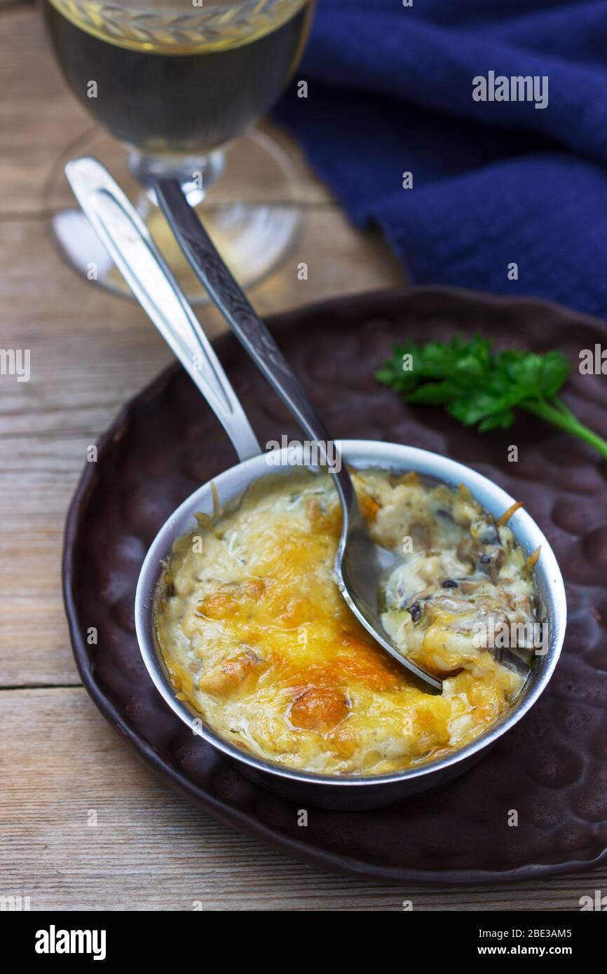 Julienne with mushrooms and bechamel sauce with cheese, served with ...