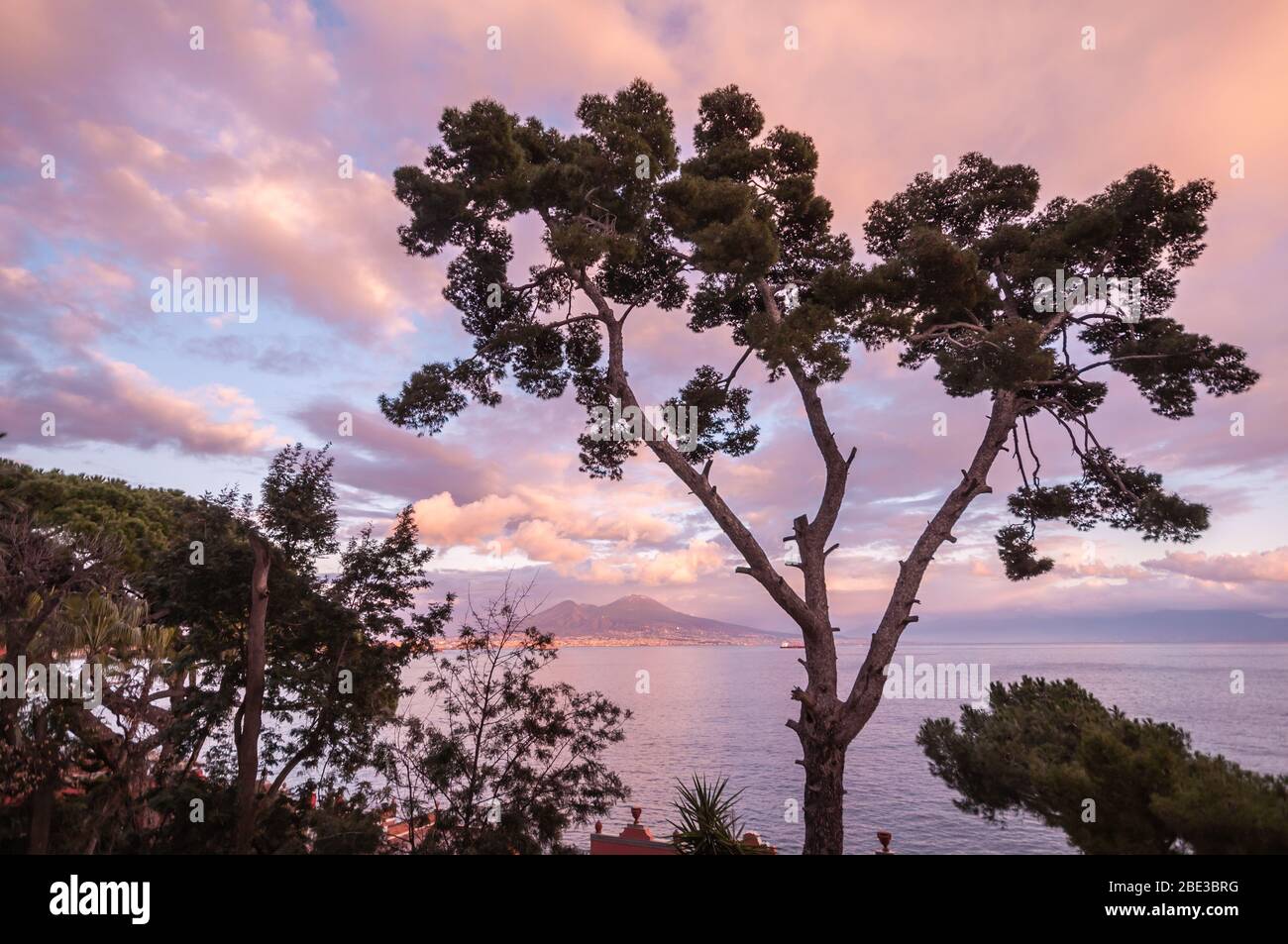 View through the trees from Posillipo of the beautiful city of Naples ...