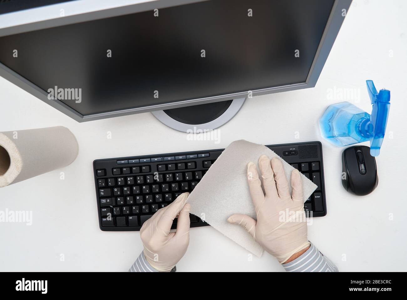 concept of cleaning or disinfecting the office - a businessman cleans ...