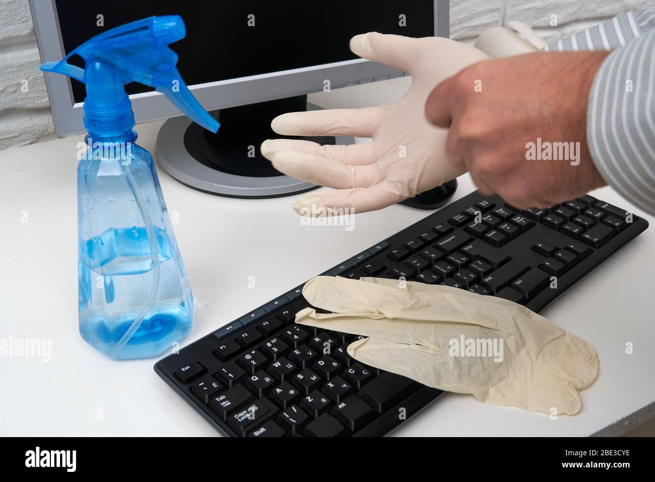 concept of cleaning or disinfecting the office - a businessman cleans ...