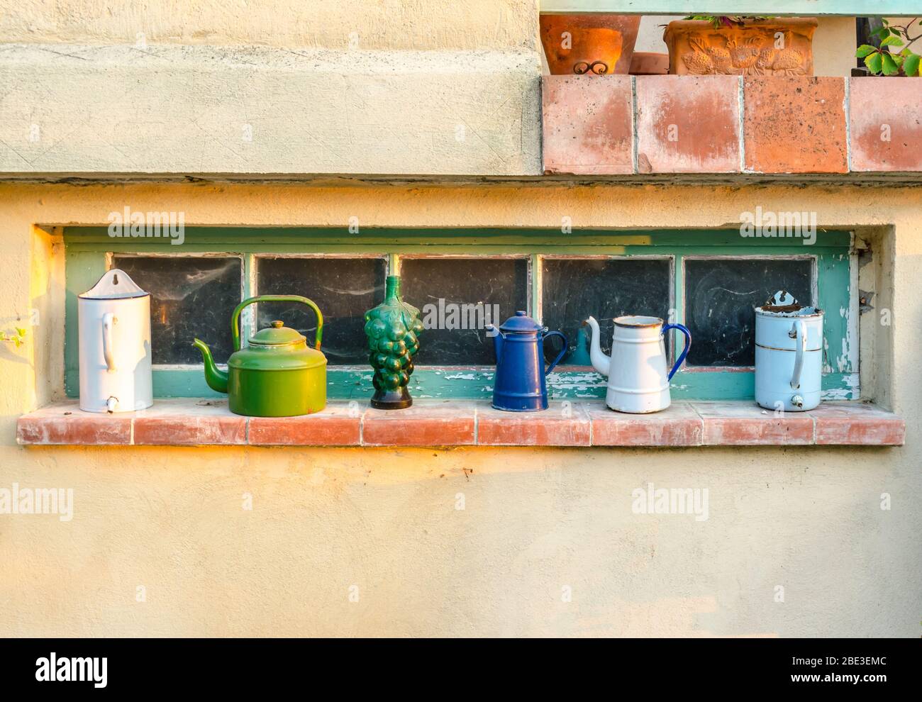 Colorful kettles on stucco shelf in Aix-en-Provence Stock Photo - Alamy