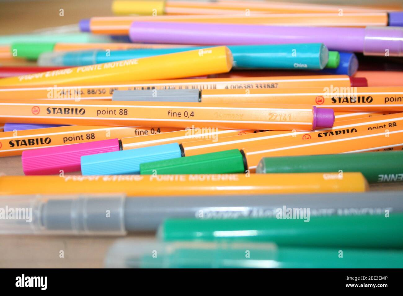 assorted coloured pens on desk Stock Photo - Alamy