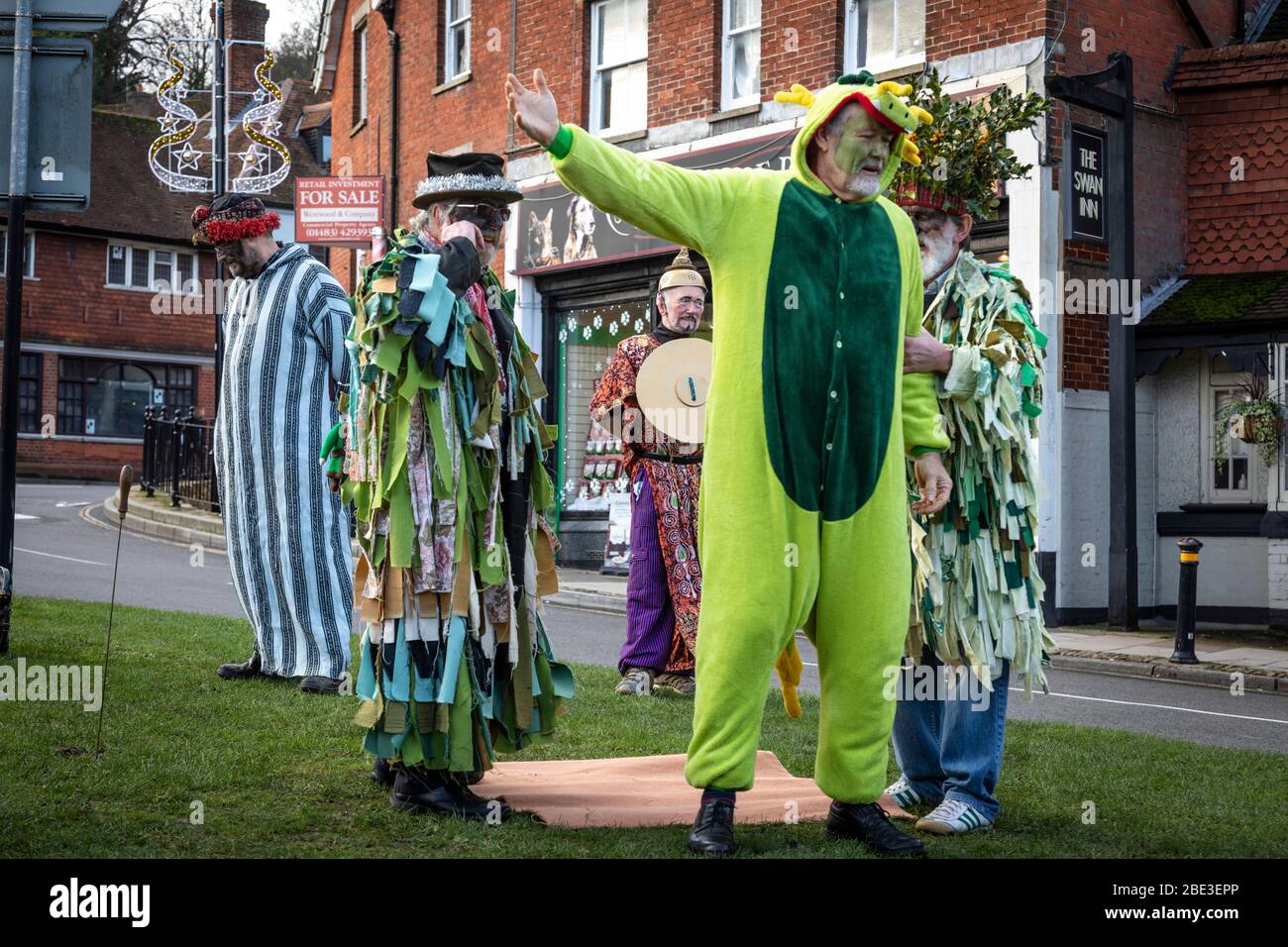 Mummers dressed in traditional costume perform in the centre of ...