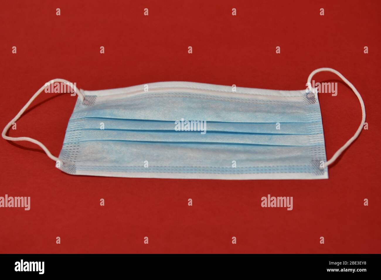 Medical protective mask on red background. Healthcare concept Stock ...