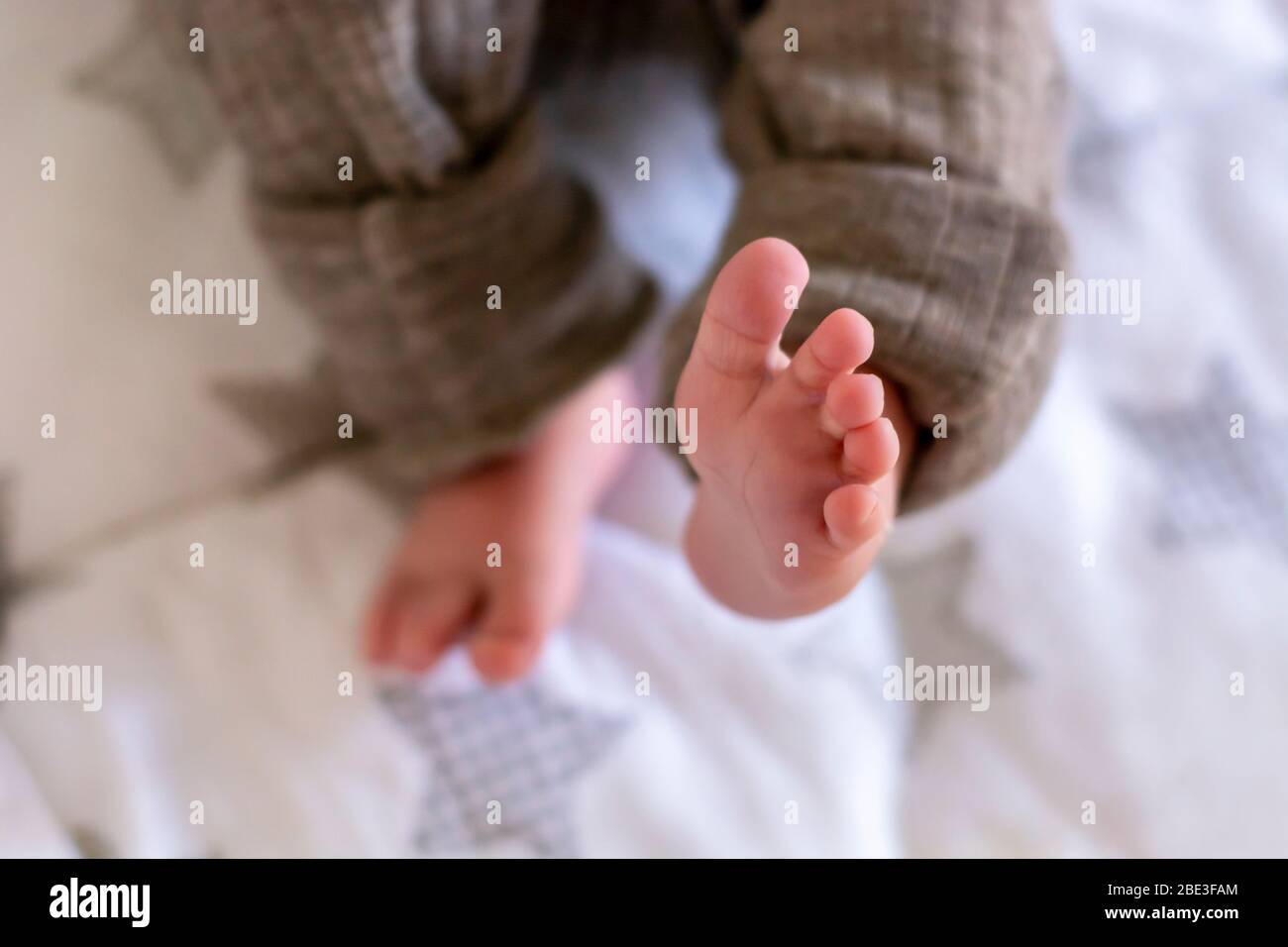 Newborn baby feet and tiny toes. View from above. Box sheet with star ...
