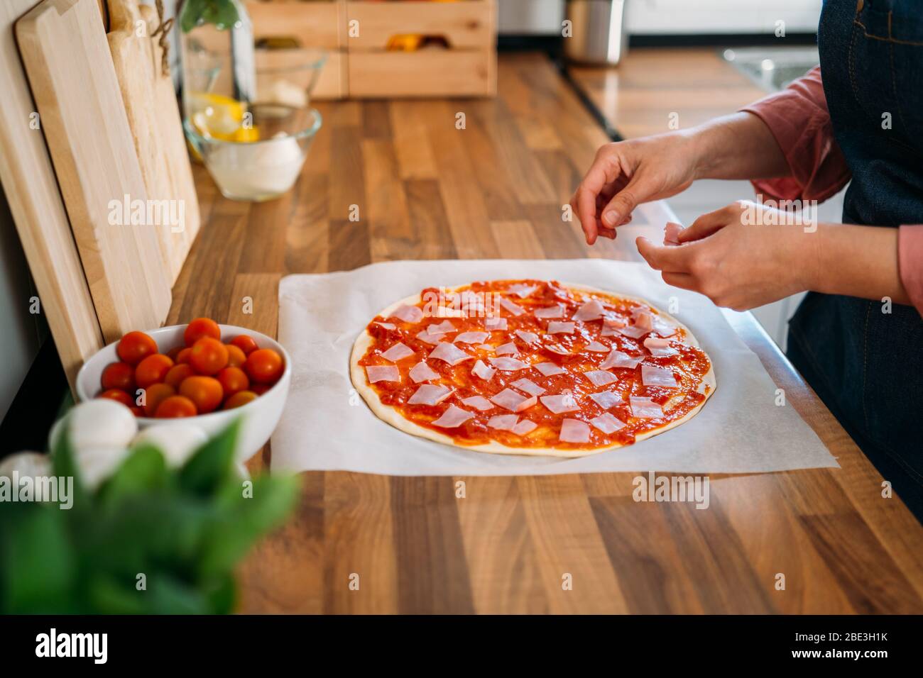 Woman preparing a traditional Italian pizza. The original process of ...