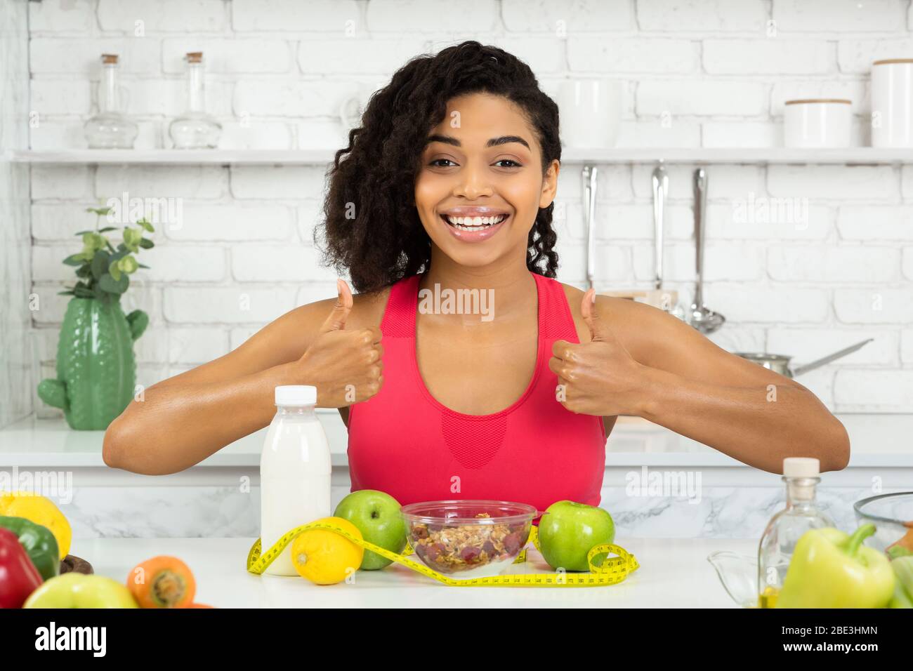 Happy young african girl showing thumbs up Stock Photo - Alamy
