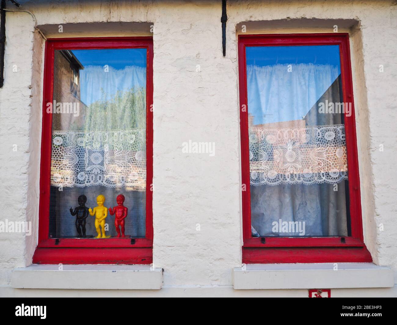 Close up of typical Belgian windows with Manneken piss statues on the ...