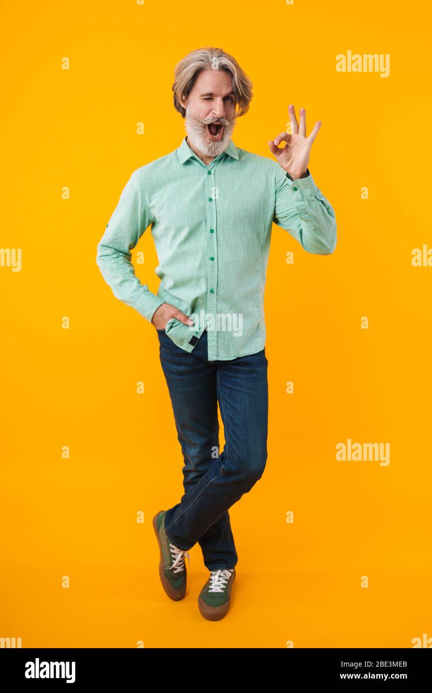 Image Of Positive Elderly Grey Haired Bearded Man In Blue Shirt Posing