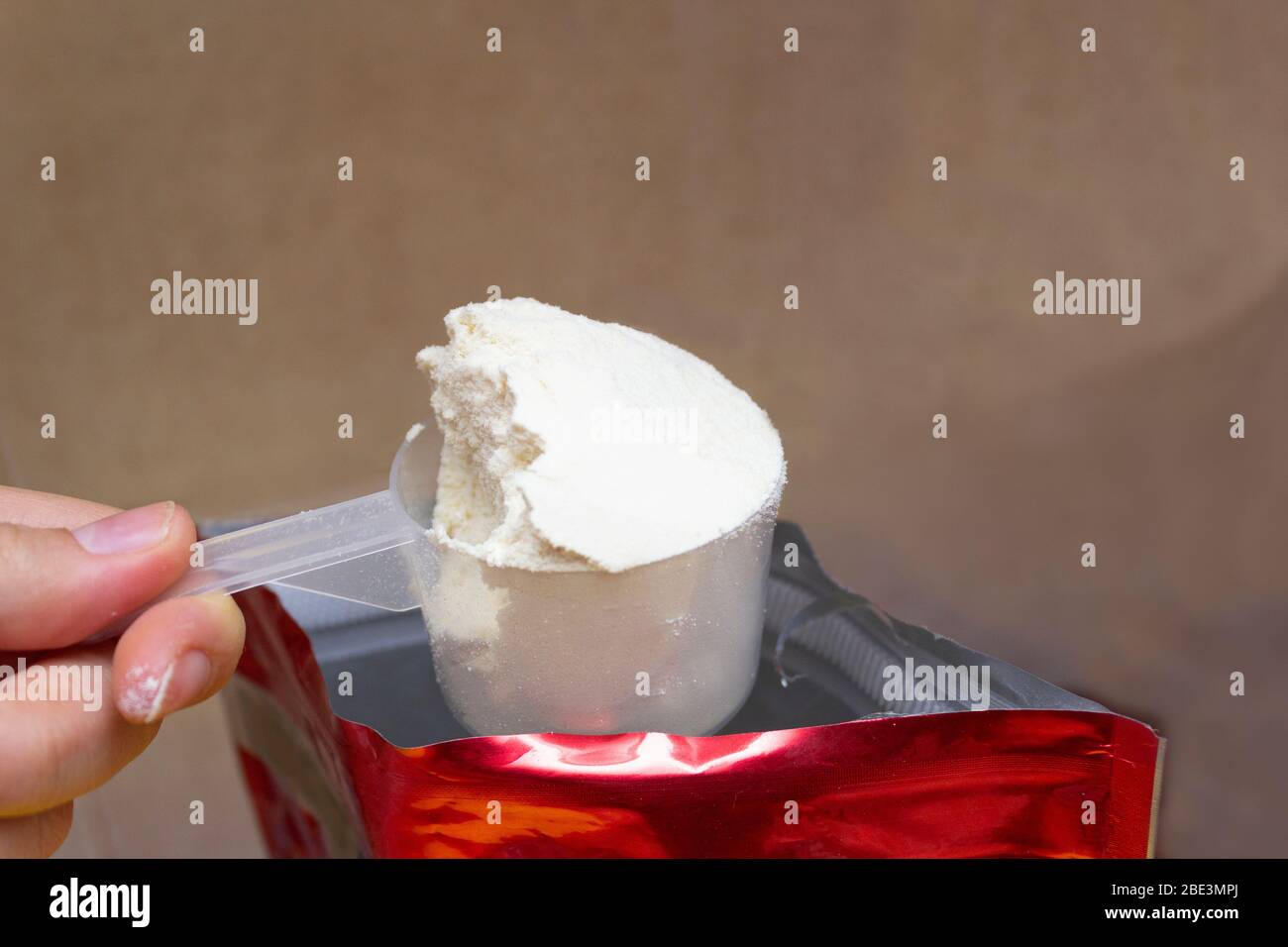 Protein powder in a measuring cup Stock Photo - Alamy