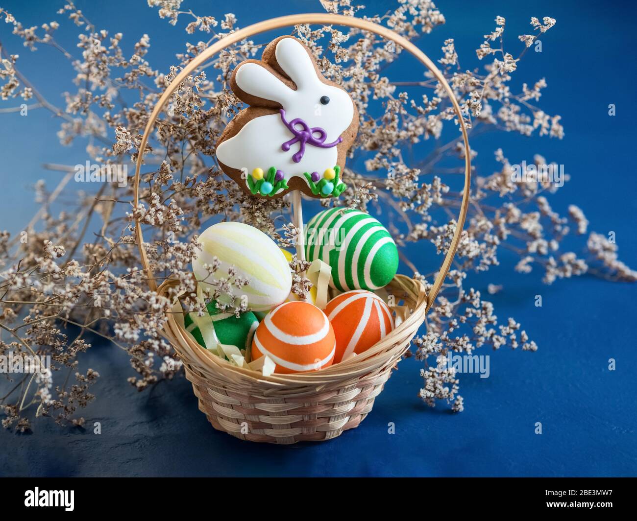 Bright colored Easter eggs and gingerbread in the shape of a rabbit ...