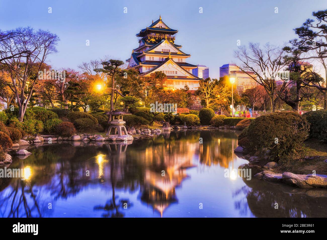 Traditional japanese garden with still pond and bright lights at ...