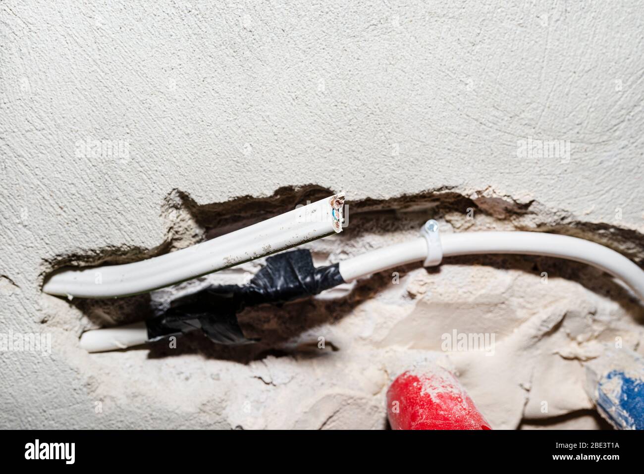 Cut single-phase cable in the wall of the house. Phase, neutral and ...