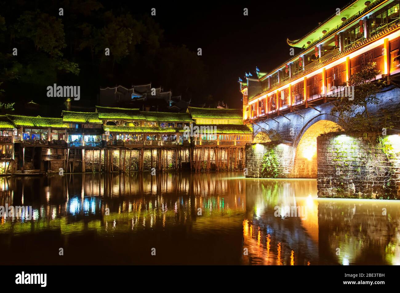 The landmark hongqiao bridge lit up at night over the tuojiang river in ...