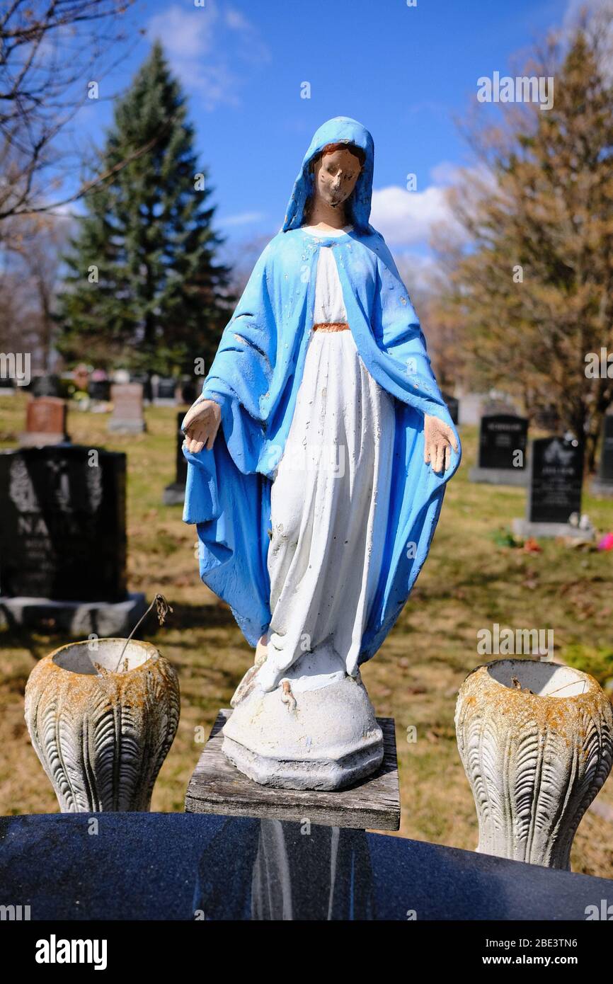 Small, brightly coloured statue of the Virgin Mary (Our Lady of Grace ...