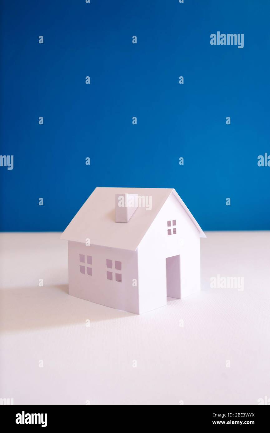 all white paper miniature house with blue color background Stock Photo ...